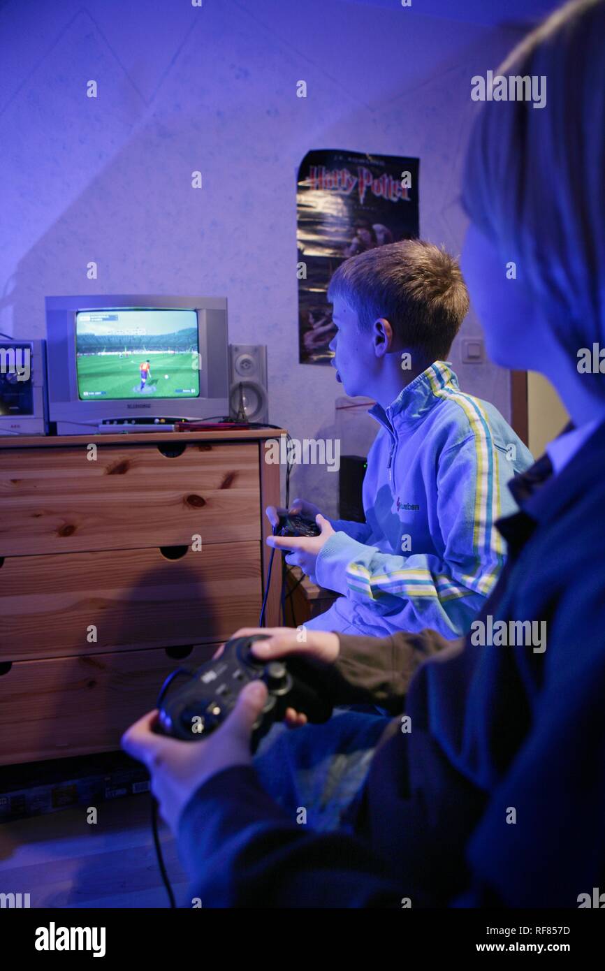 Boys home playing a playstation soccer hi-res stock photography and ...