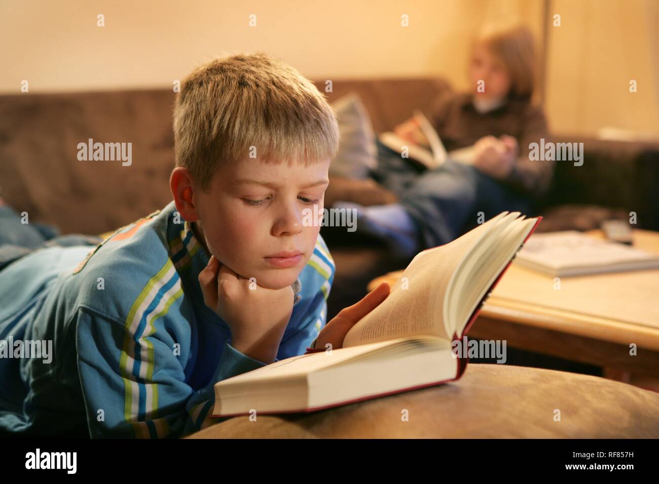 Germany : Boys are reading a book, at home Stock Photo - Alamy