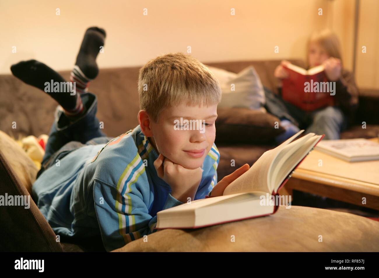 Germany : Boys are reading a book, at home Stock Photo - Alamy