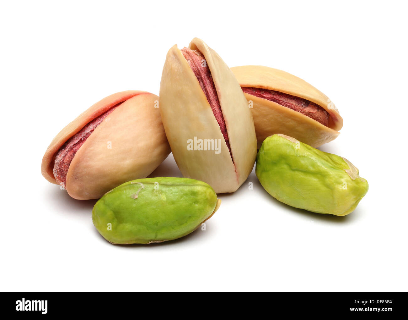 Peeled and whole pistachio nuts isolated on white background Stock ...