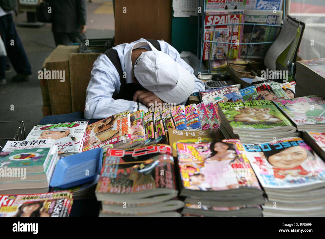 Newspaper salesman takes a nap, Tokyo, Japan, Asia Stock Photo - Alamy