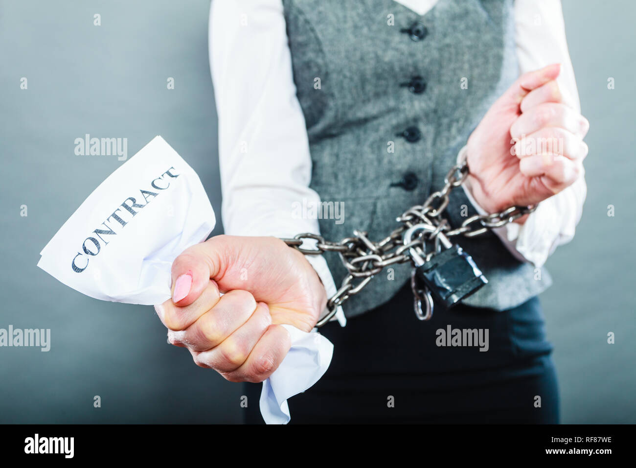 Business concept. Serious woman businesswoman with chained hands ...
