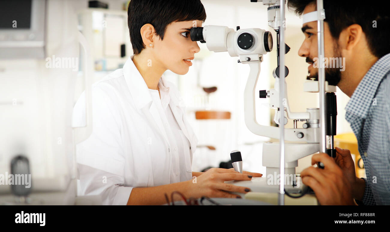 Professional female optometrist consulting male hi-res stock ...