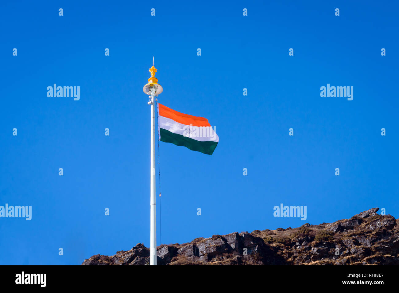 Indian tricolor national flag on a flagpole, waving in wind on mountain ...