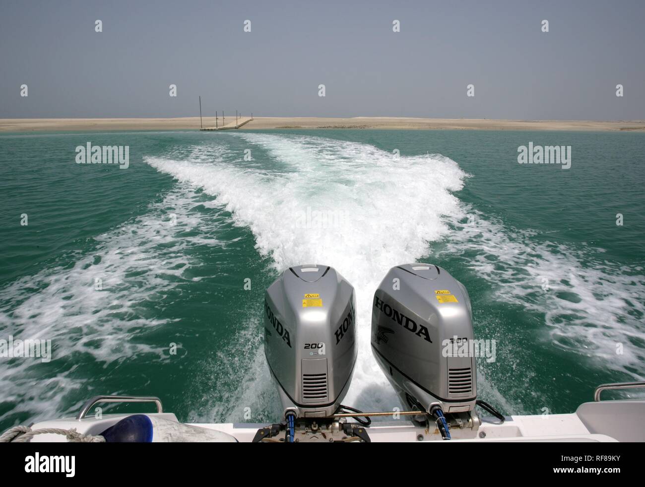 Churned water from a boat off of one of the artificial islands on a man ...