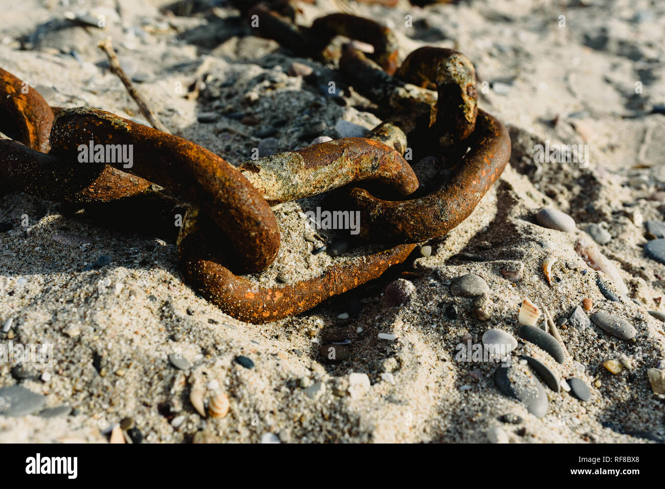 Antique rusty chain in sand hi-res stock photography and images - Alamy