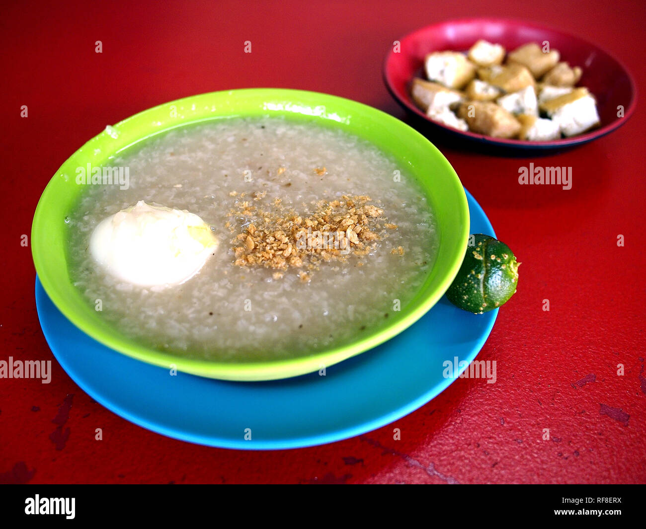 Photo of freshly cooked rice porridge with egg and pork innards ...