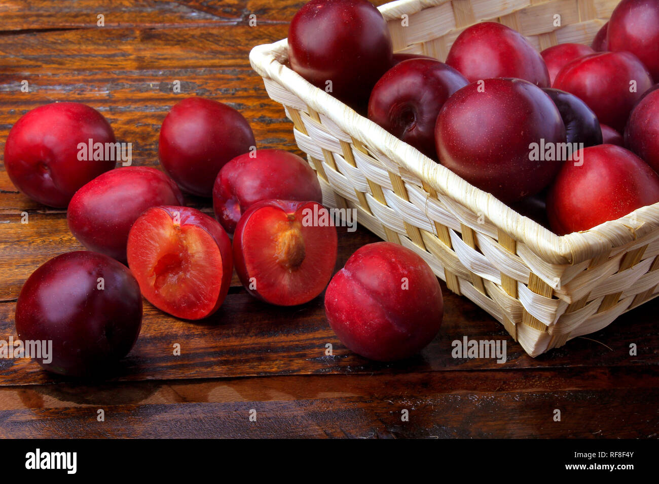 raw and fresh organic plums inside rustic fabric wooden box on rustic ...