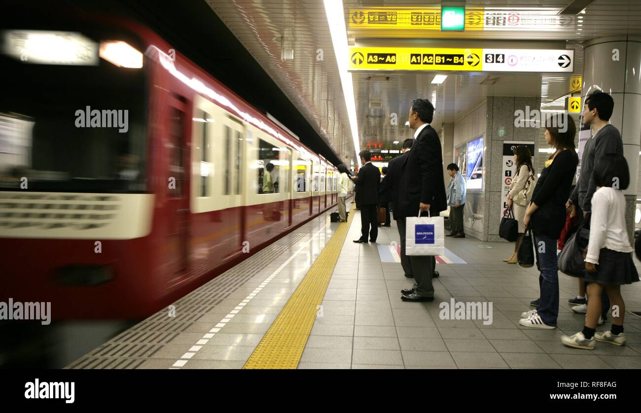 Japan, Tokyo: Tokyo Metro, platform JR Line, local train, conductor ...