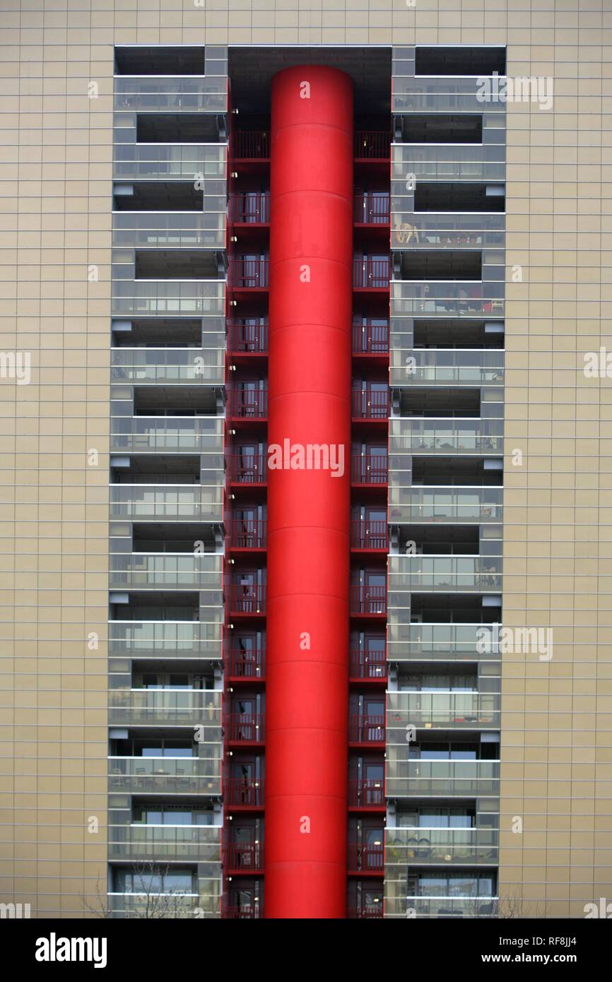 Facade of a modern apartment building with red elevator shaft ...