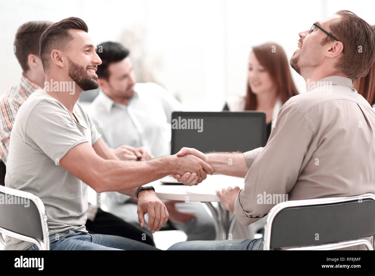close up.handshake employees at the Desk Stock Photo - Alamy