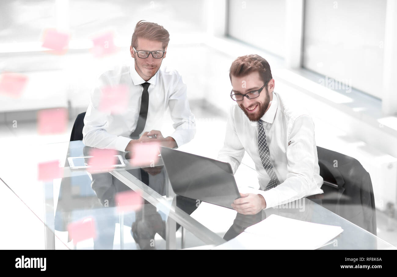 two happy employees reading a business document Stock Photo - Alamy