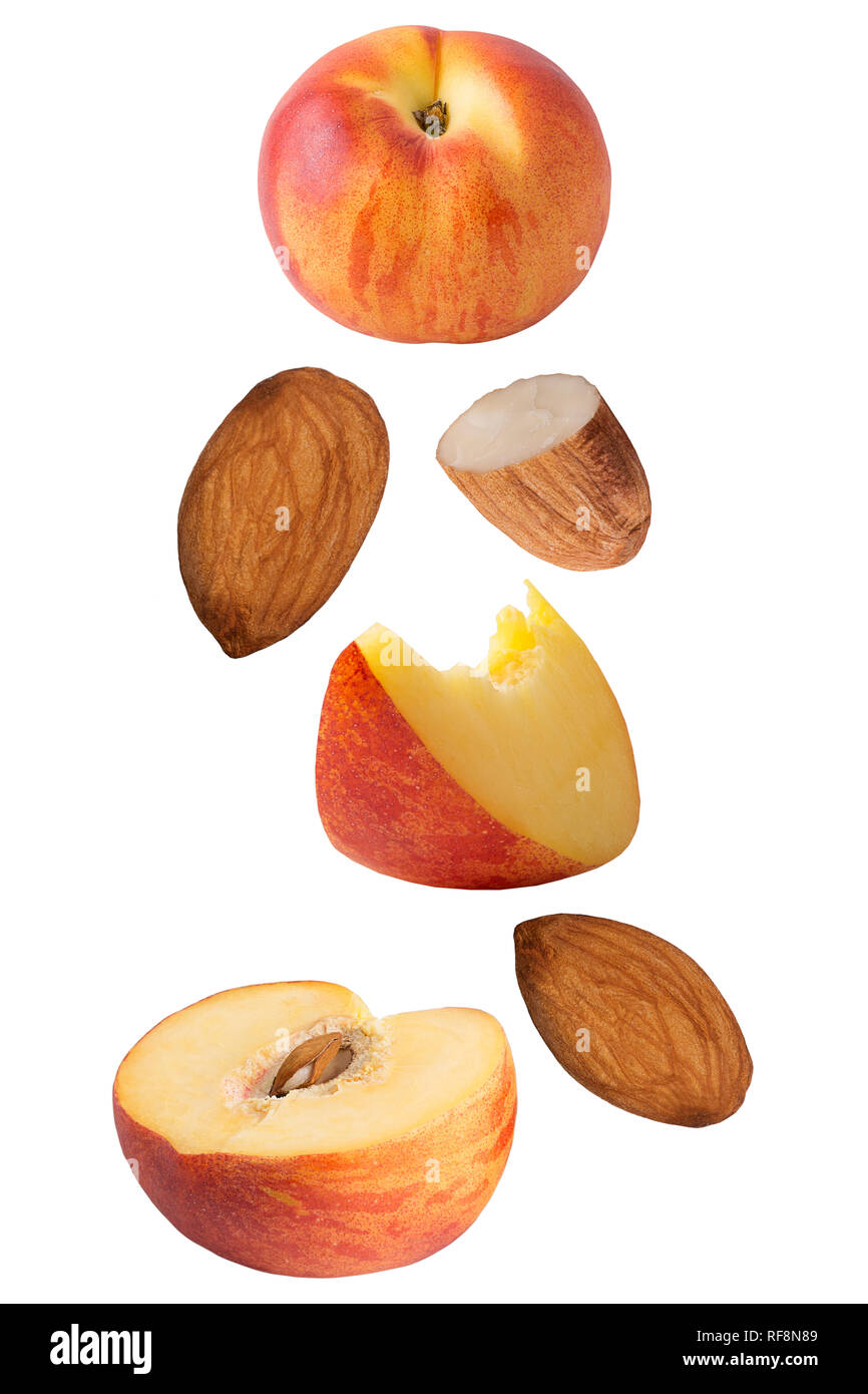 Flying fruits. Falling peach and almonds isolated on white background ...