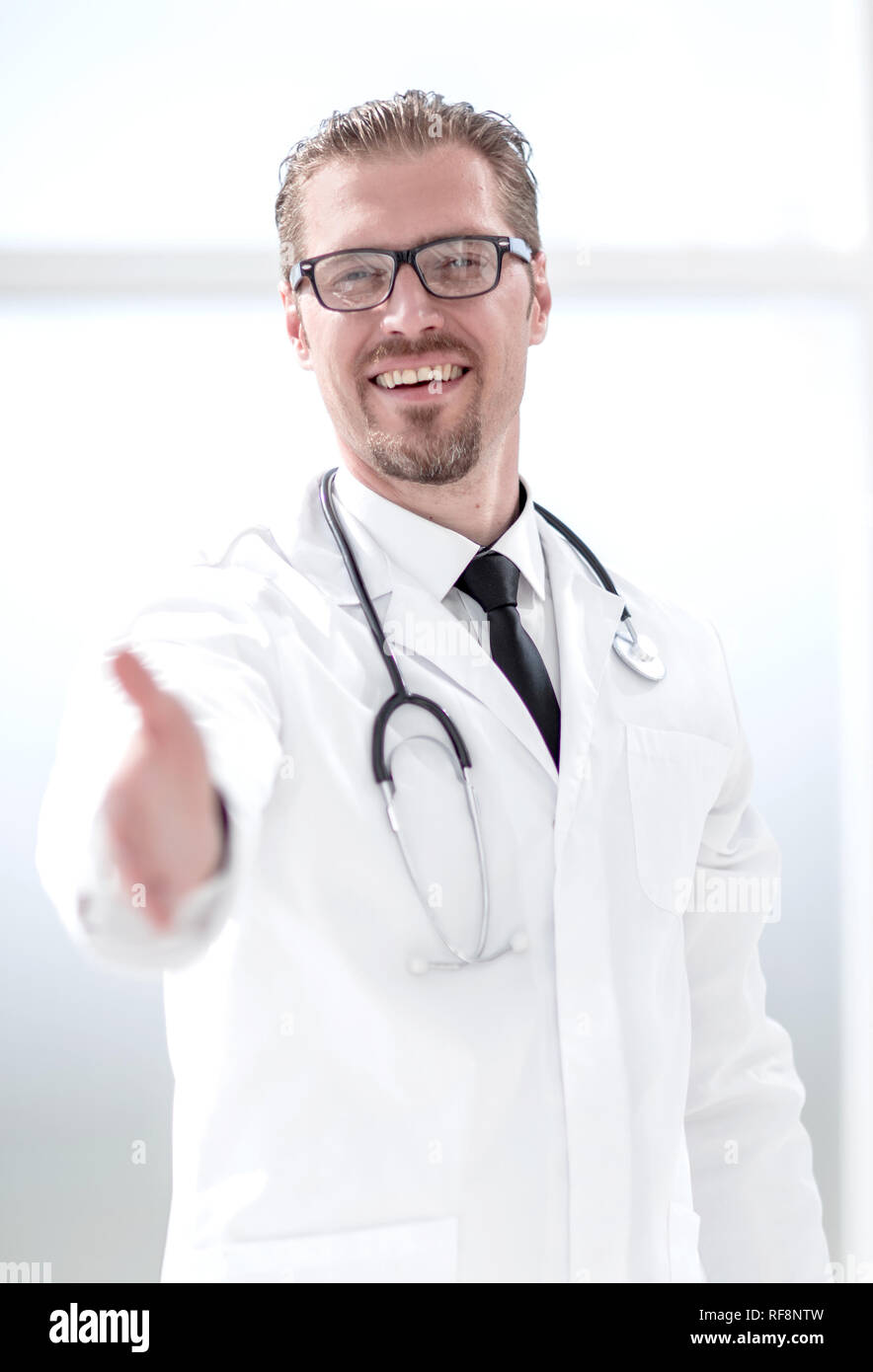 Healthcare professional extending hand hi-res stock photography and ...