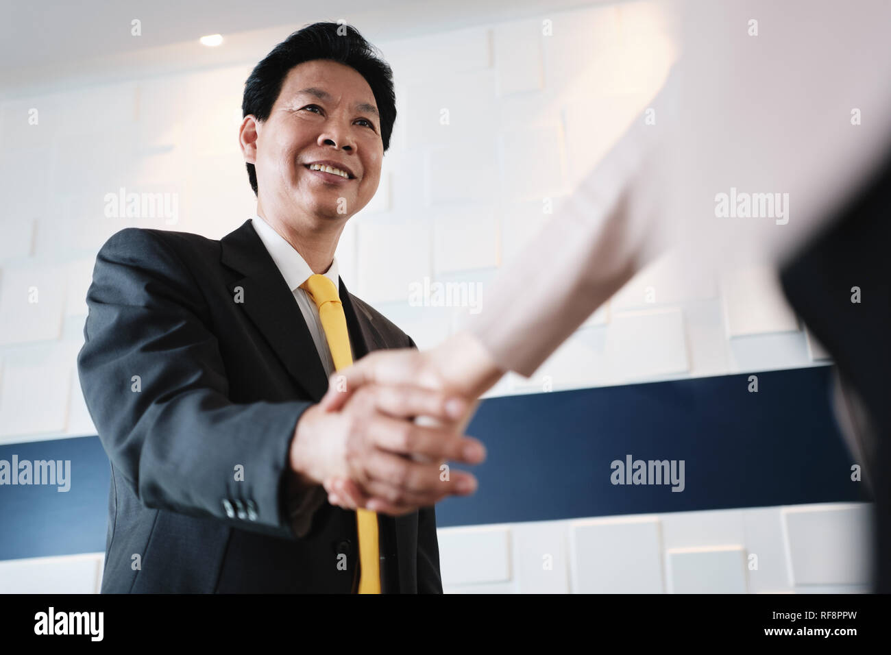 Handshake Between Happy Asian Manager And Hispanic Businesswoman In ...