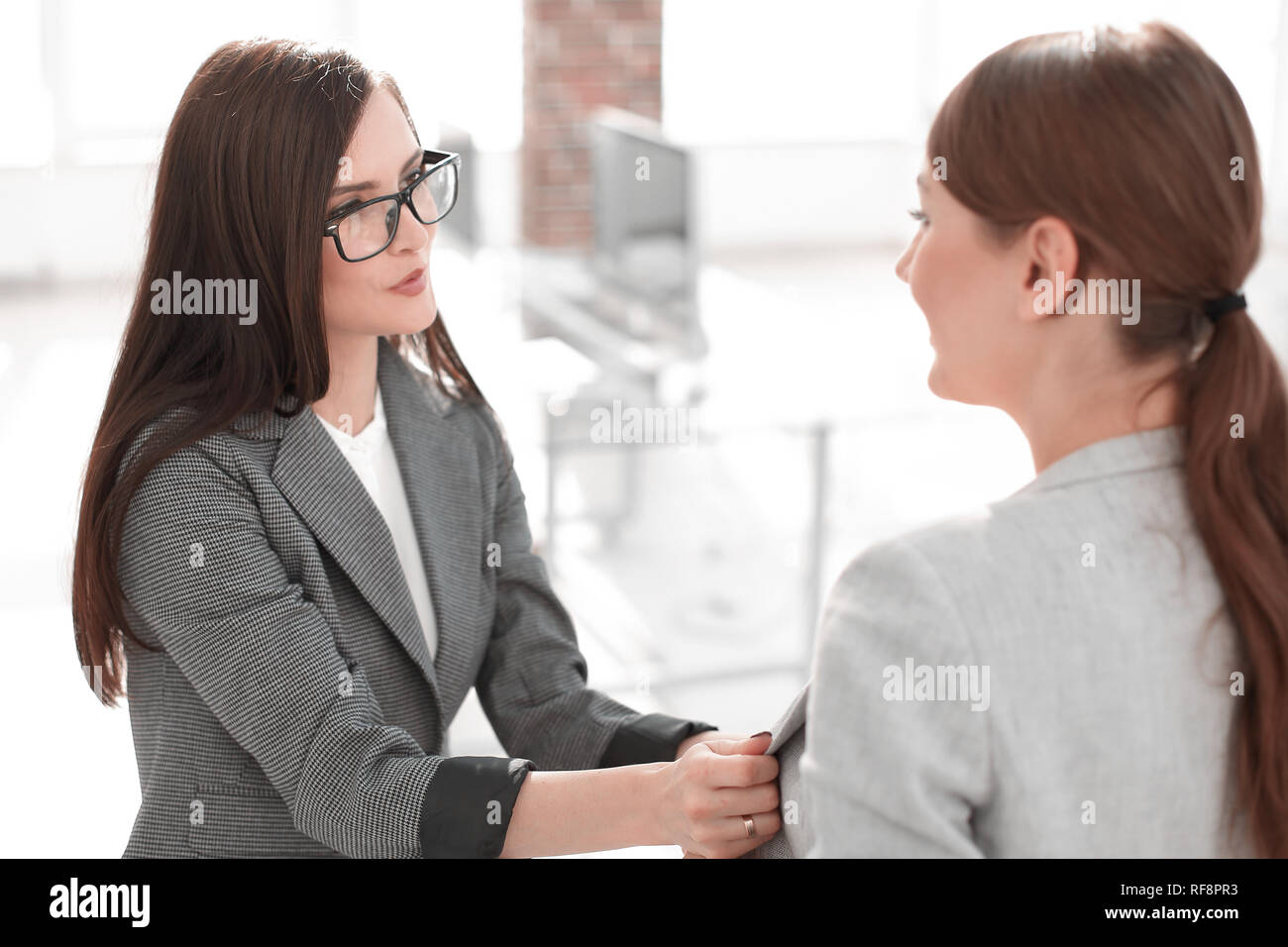 two employees on the background of a modern office Stock Photo - Alamy