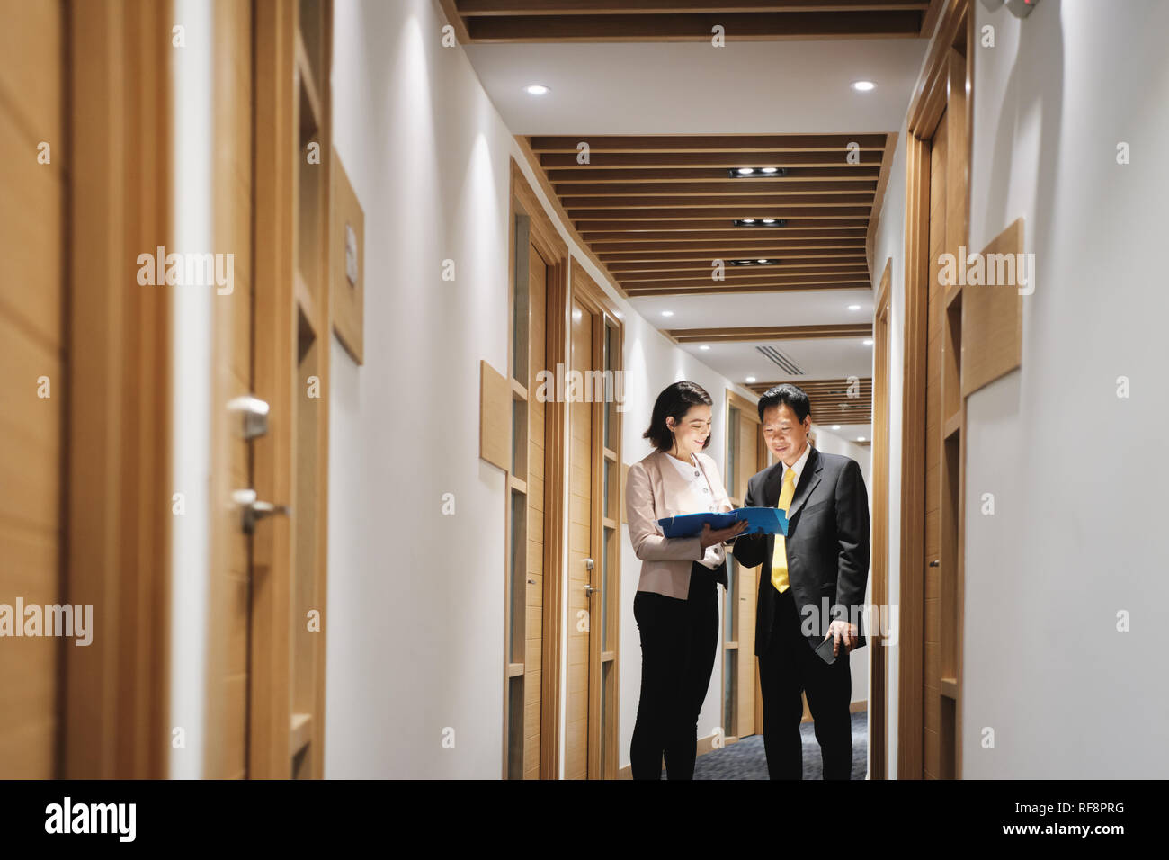 Businesswoman Explaining Documents To Happy Chinese Client In Bank ...