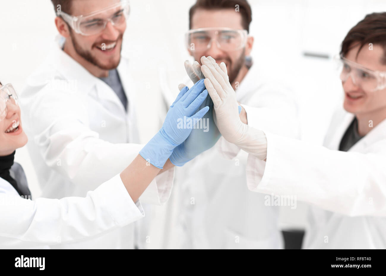 scientists giving each other a high five Stock Photo - Alamy