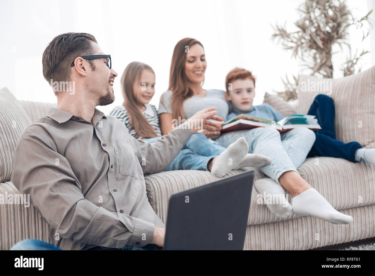 happy family spends their free time in their living room Stock Photo ...