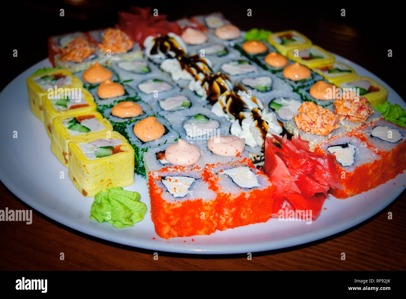 Big set of different rolls on a white dish. many rolls, a big set over ...