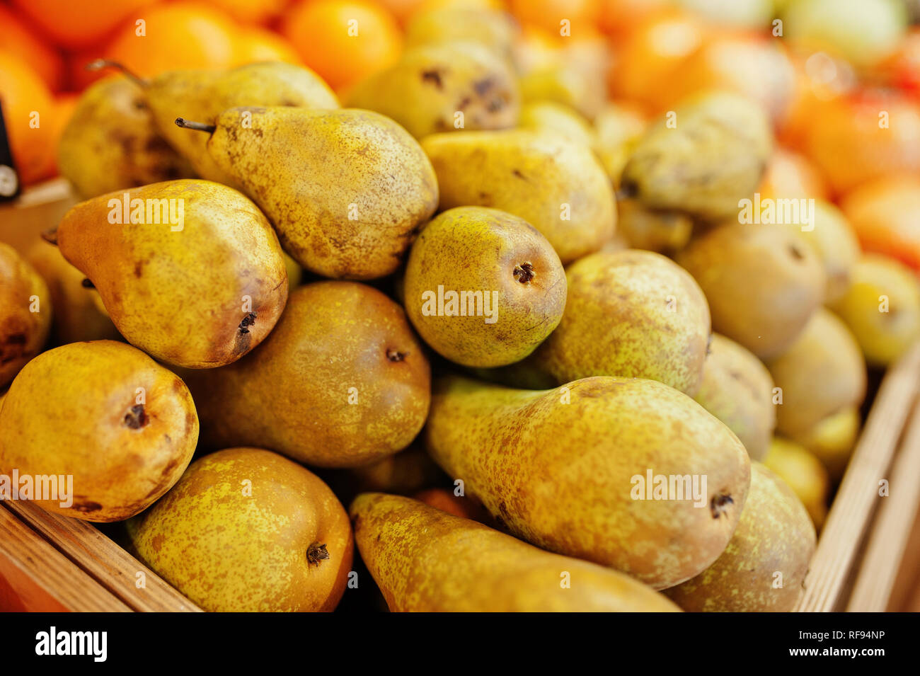 Colorful shiny fresh fruits. Pears on the shelf of a supermarket or ...