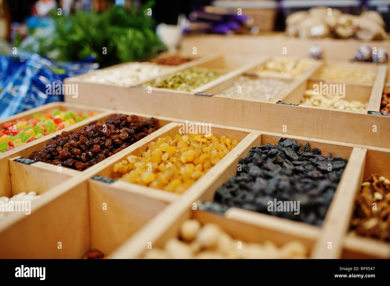 Raisins, nuts and candied fruits on the shelf of a supermarket or ...