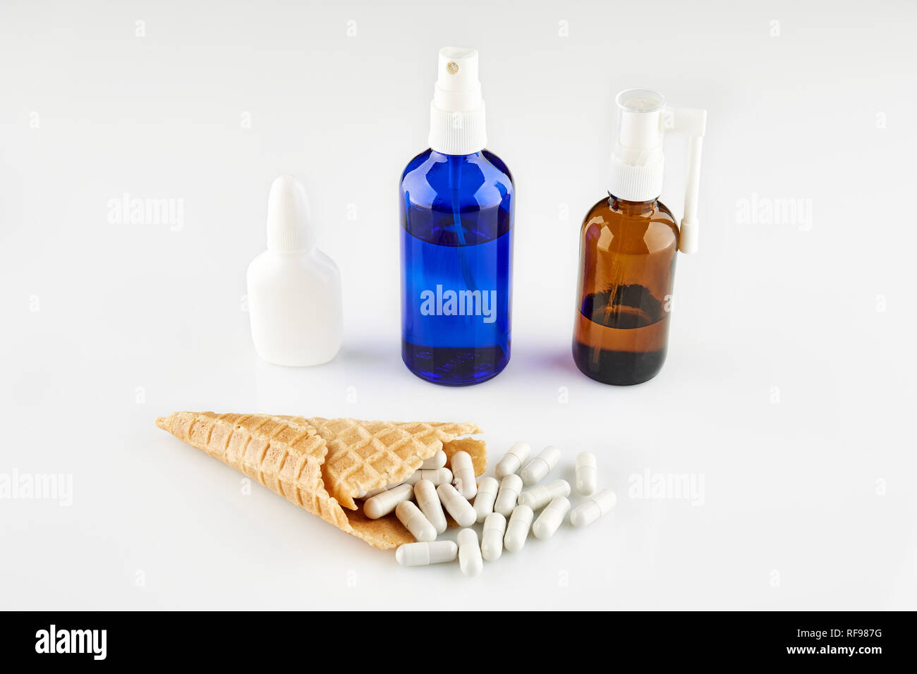 Colorful bottles and ice-cream cup with medicine on white background ...
