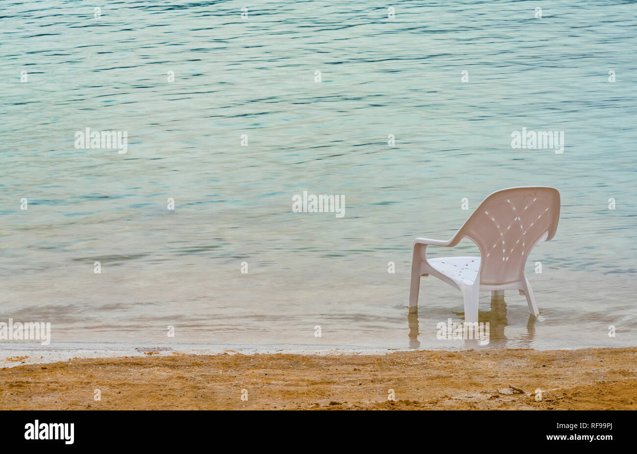 Plastic chair in the Dead Sea waters Stock Photo - Alamy