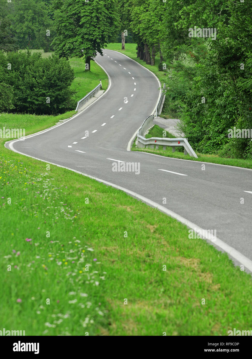 Asphalt winding curve road in nature Stock Photo - Alamy