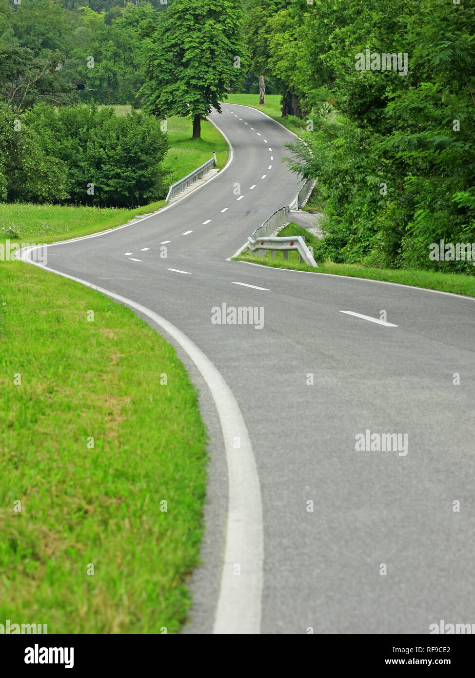 Asphalt winding curve road in nature Stock Photo - Alamy