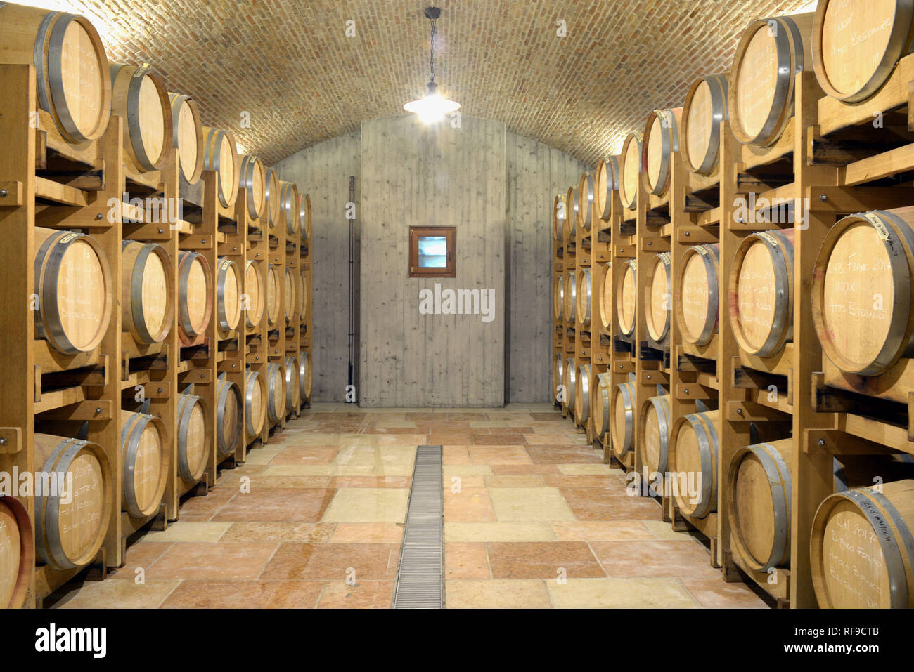 Wine aging in barrels in cellar. Diesel Farm, where since 1999 Renzo ...