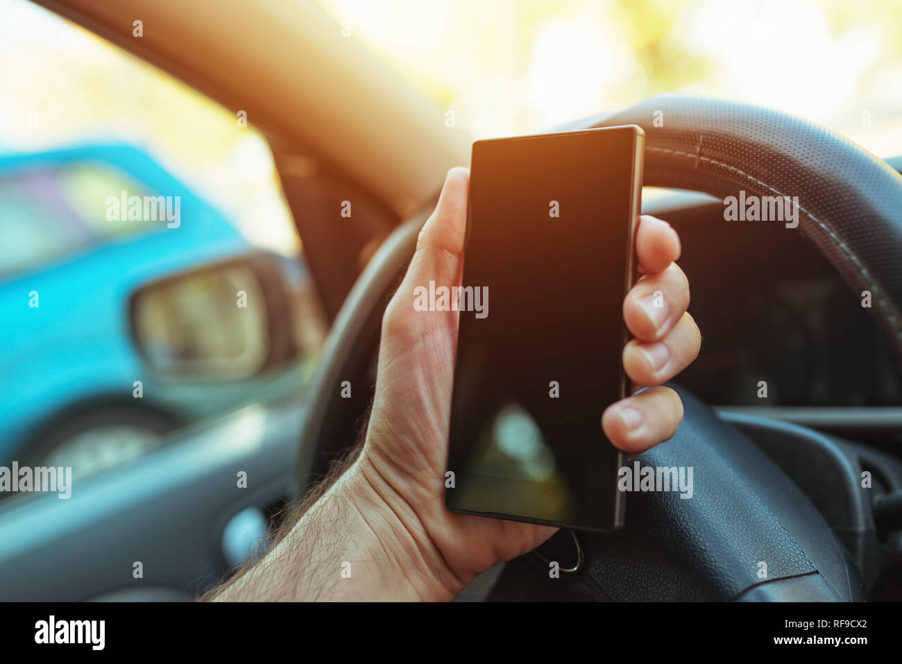 Driving car and using telephone, smartphone in male hand Stock Photo ...