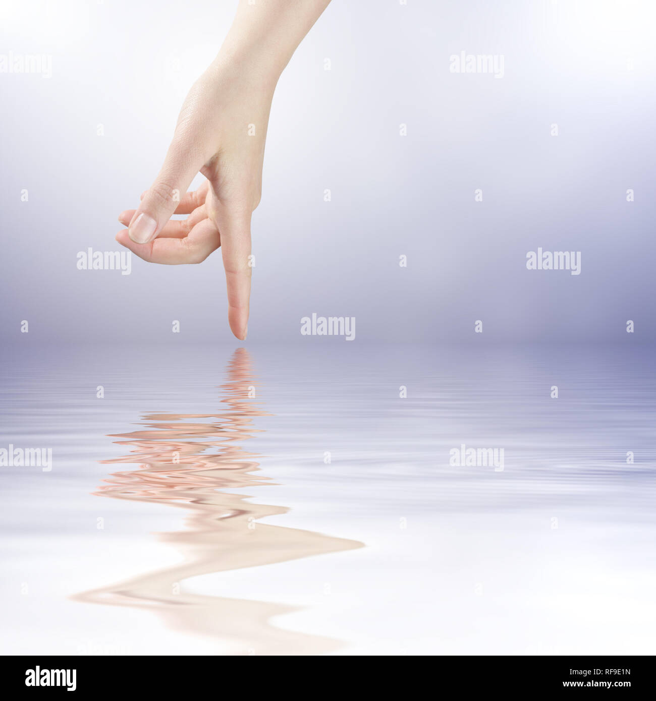 Female finger touching the water surface level Stock Photo - Alamy