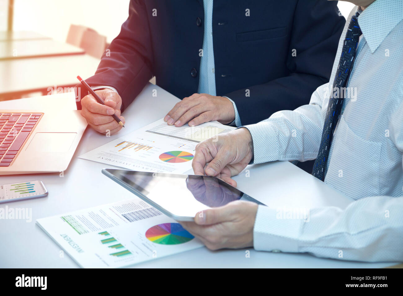 Businessman is deeply reviewing a financial reports for a return on ...