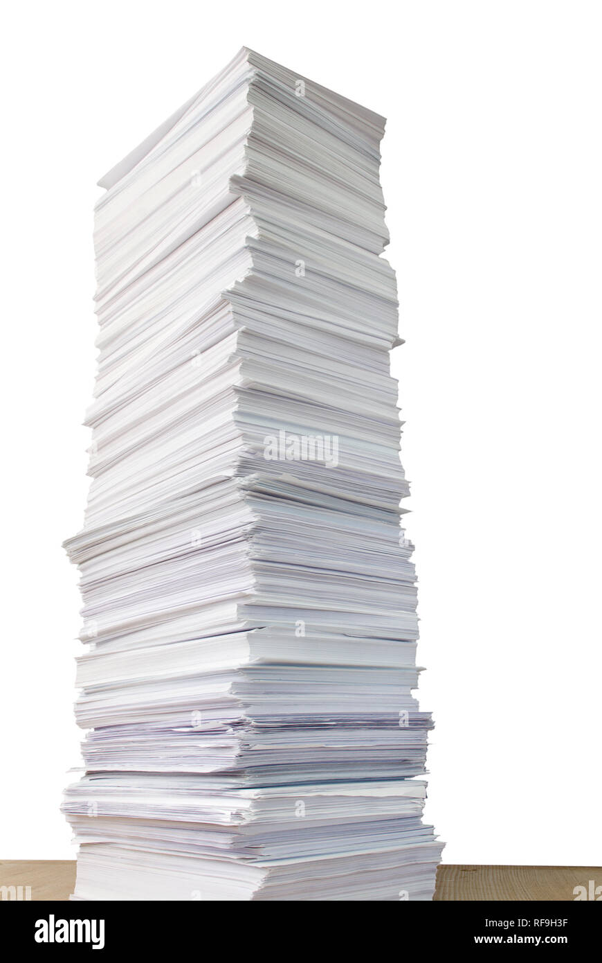 Tall stack of paper on a wooden table isolated on white background ...