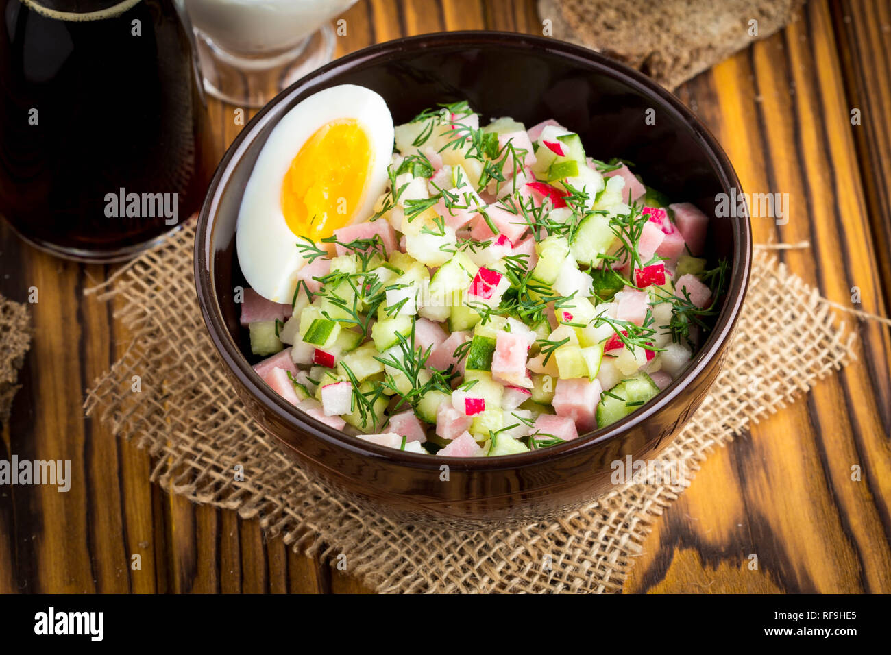 Traditional summer Russian cold soup with kvass, okroshka with ham and ...