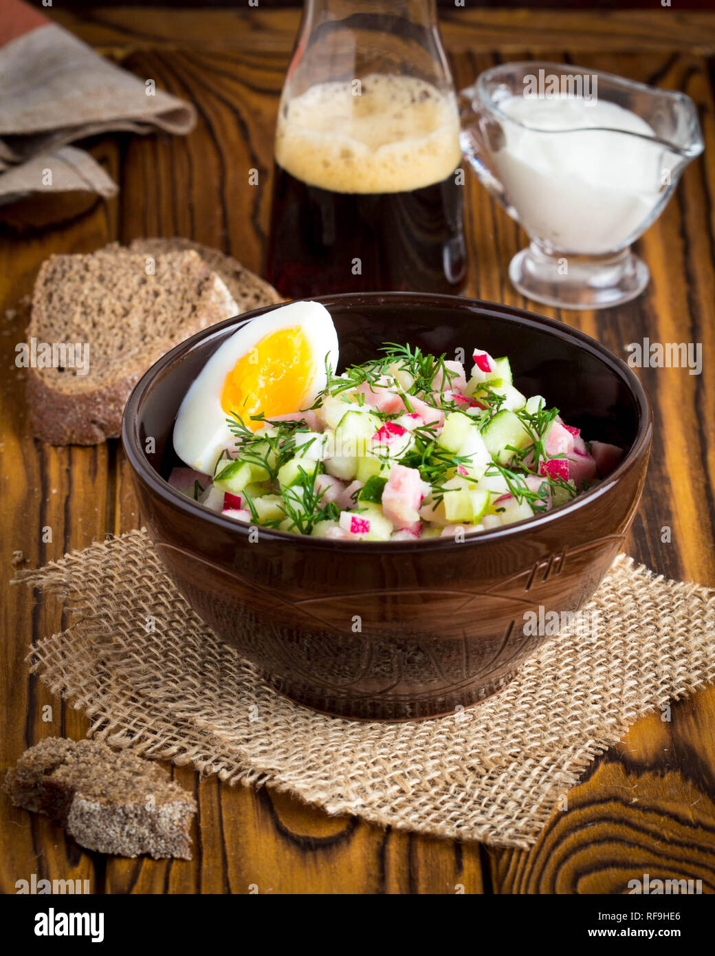 Traditional summer Russian cold soup with kvass, okroshka with ham and ...