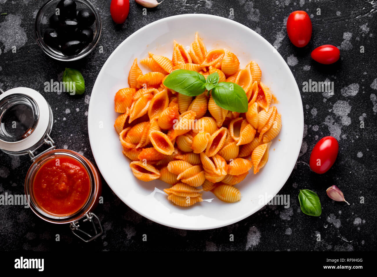 Italian shell pasta with tomato sauce, olives and Basil, classic food ...