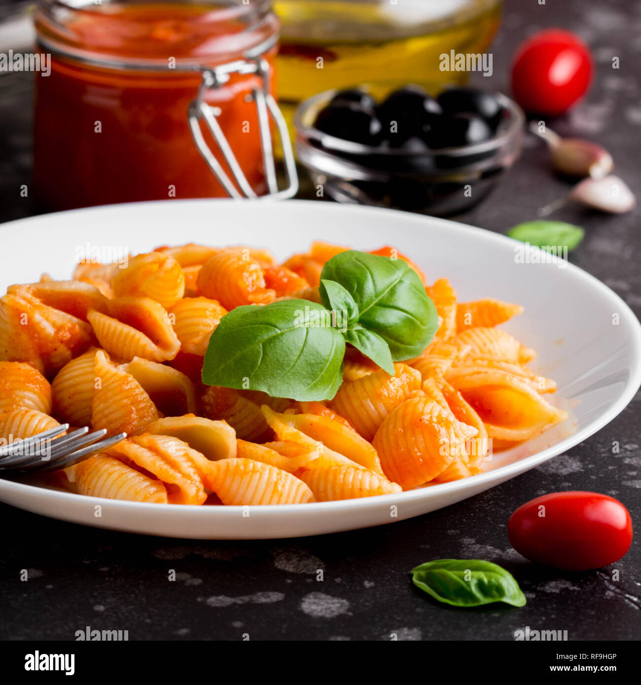 Italian shell pasta with tomato sauce, olives and Basil, classic food ...