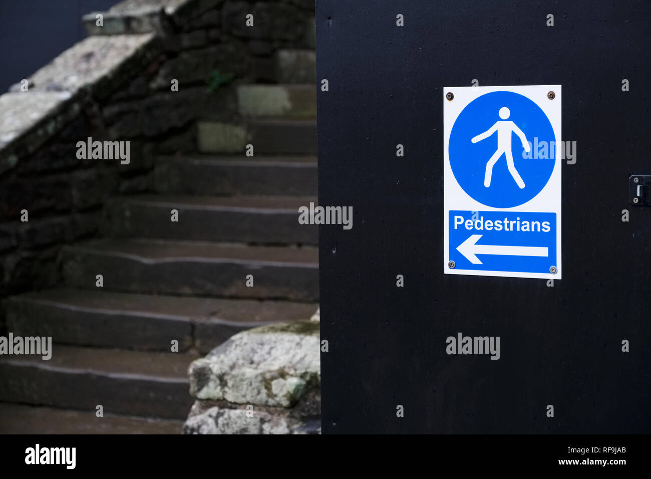 Pedestrians direction arrow sign and steps Stock Photo - Alamy