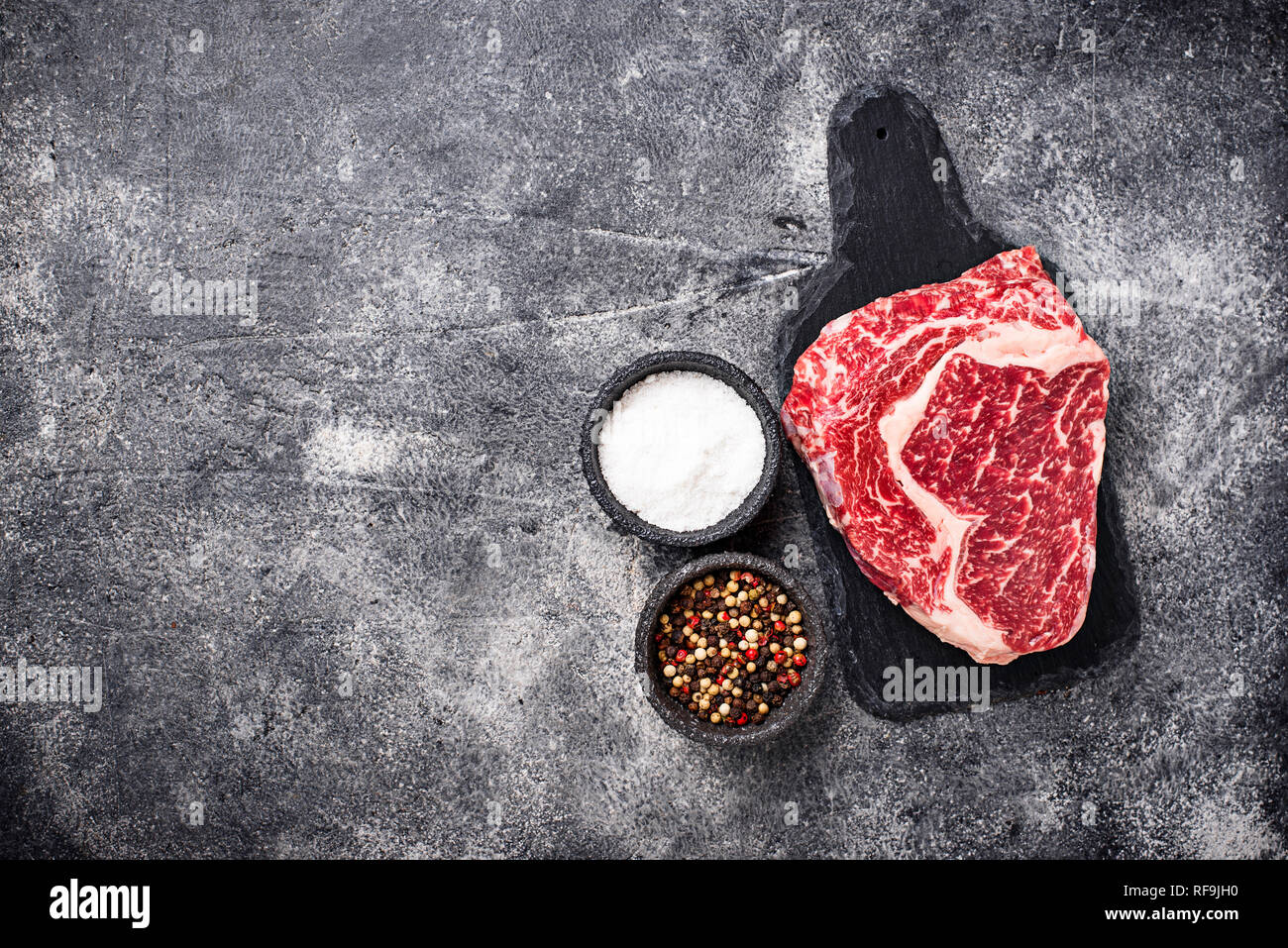 Raw marbled ribeye steak and spices Stock Photo - Alamy