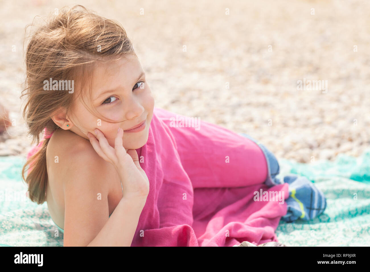 Cute happy smiling Caucasian little girl rests on the beach Stock Photo ...