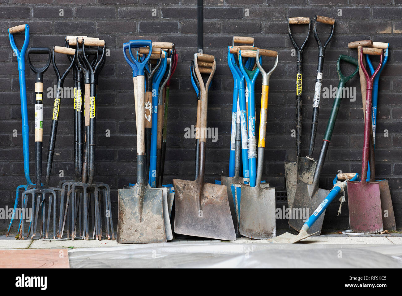 Garden tools lined up against a wall. London. October 2011 Stock Photo ...