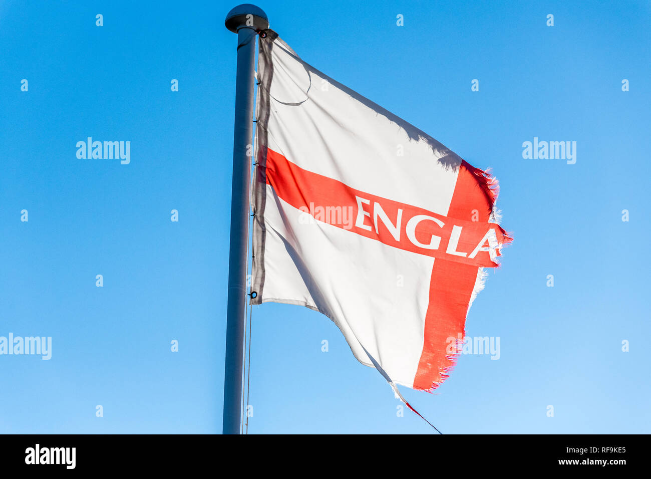 Weather beaten English flag. All torn and ripped Stock Photo - Alamy