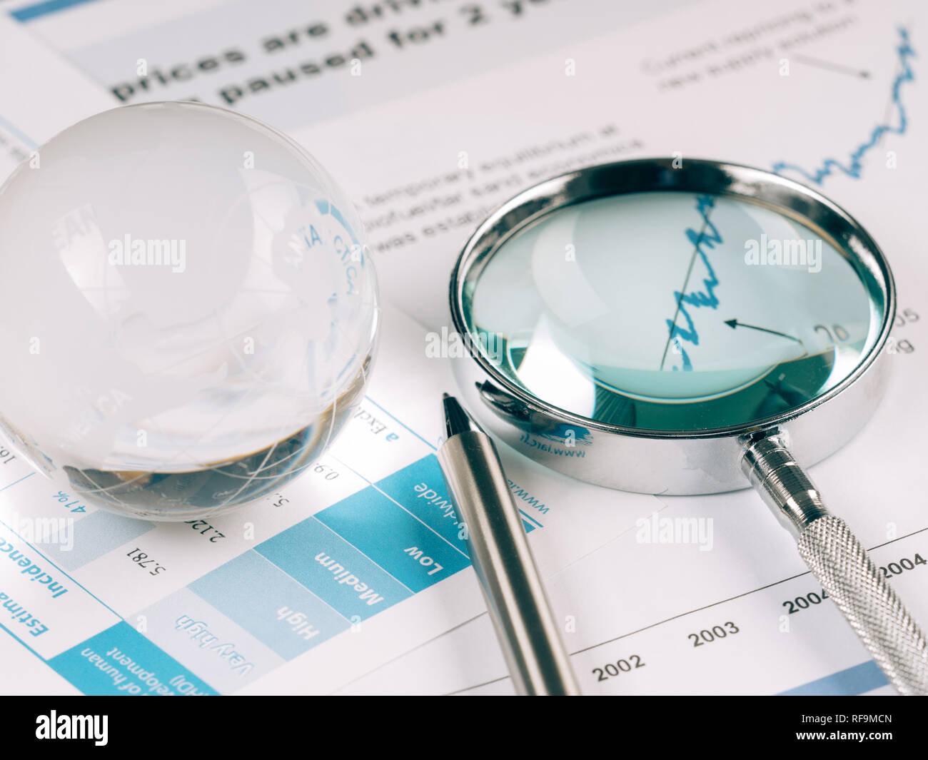 Business Data Analyzing, with magnifying glass and other on the desk ...