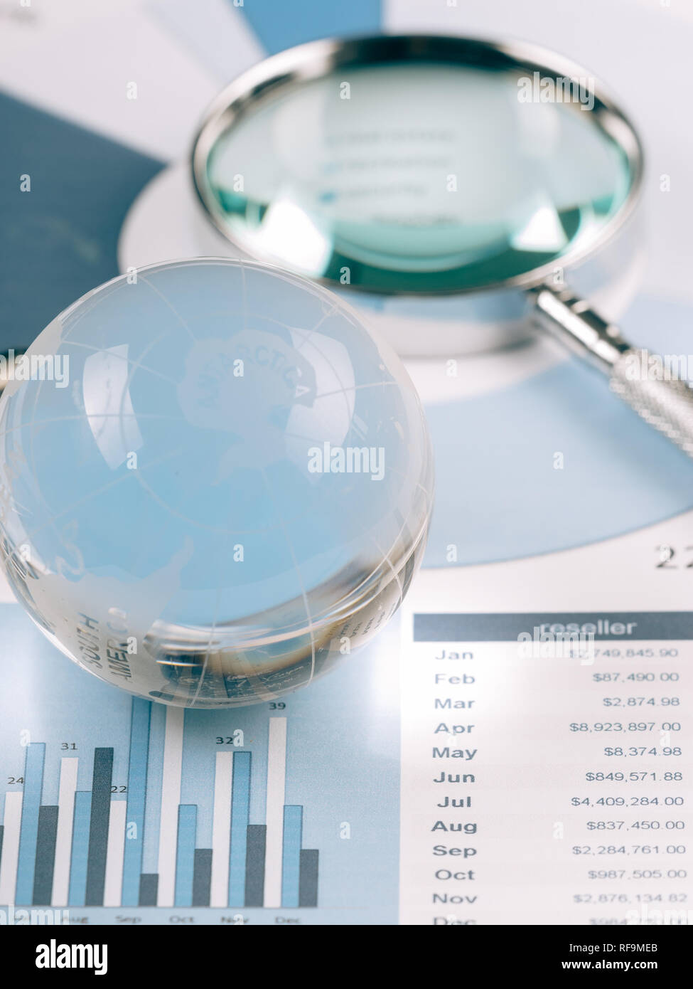 Business Data Analyzing, with magnifying glass and other on the desk ...