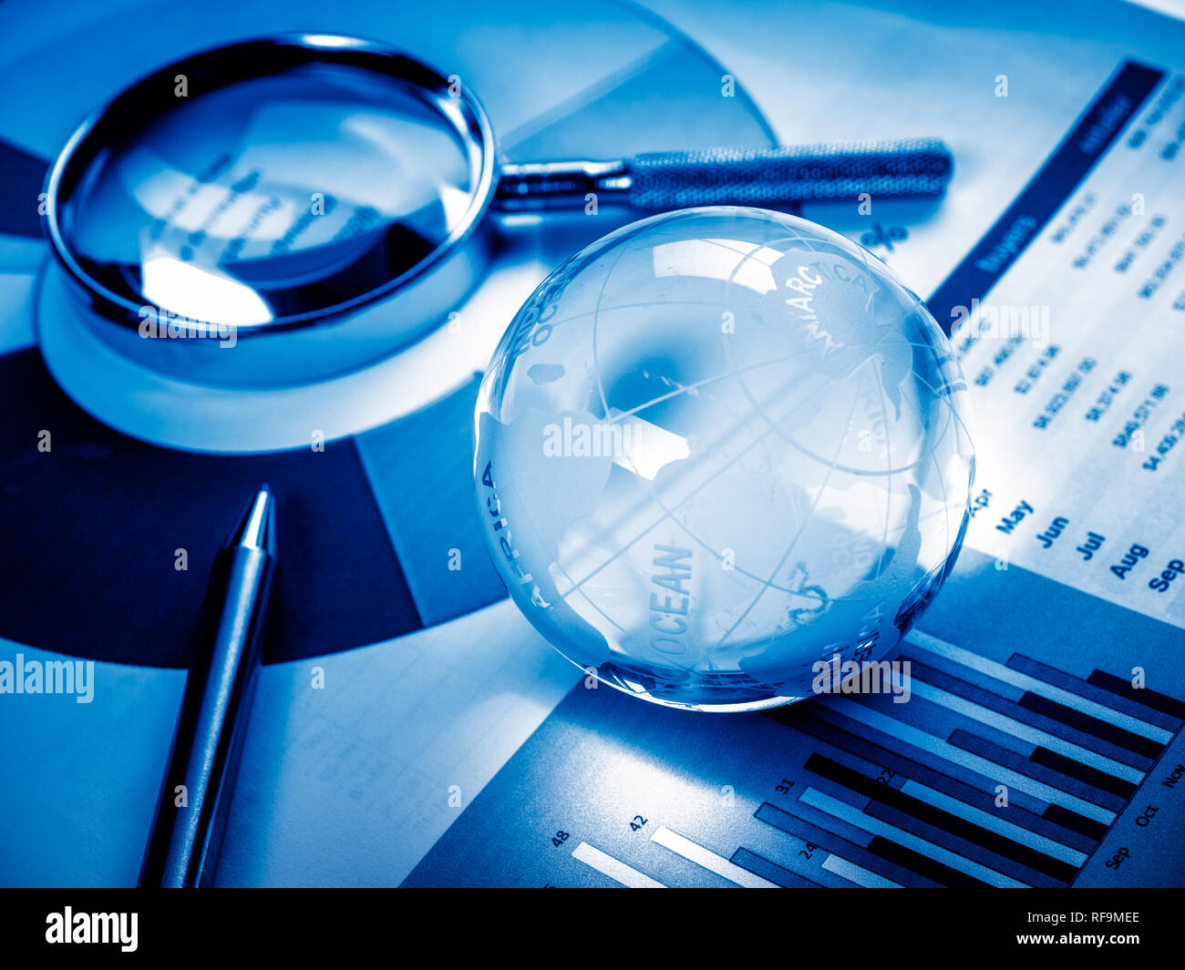 Business Data Analyzing, with magnifying glass and other on the desk ...