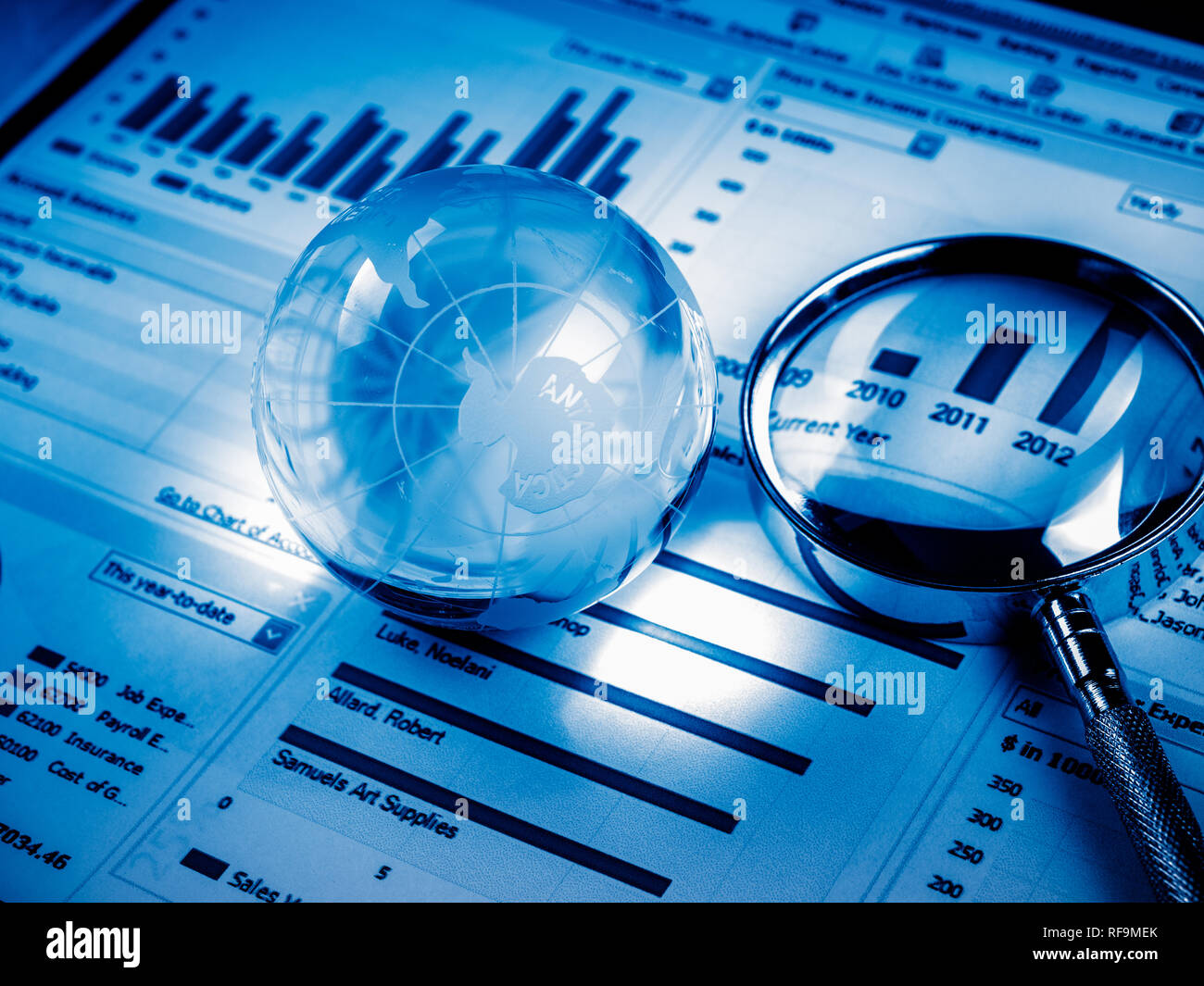 Business Data Analyzing, with magnifying glass and other on the desk ...
