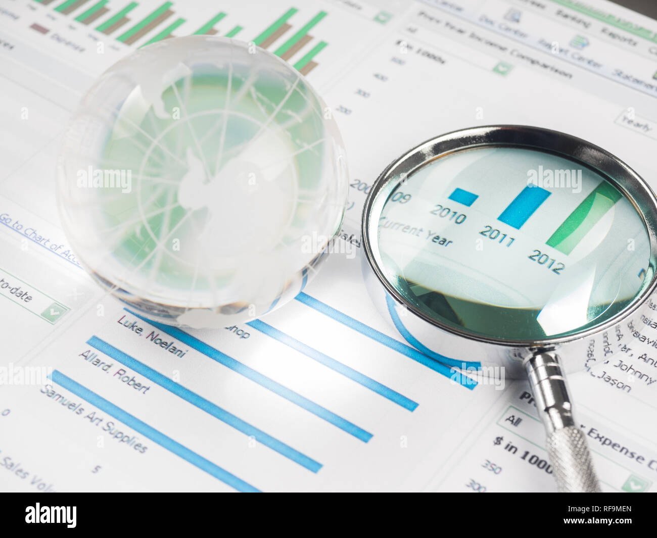 Business Data Analyzing, with magnifying glass and other on the desk ...