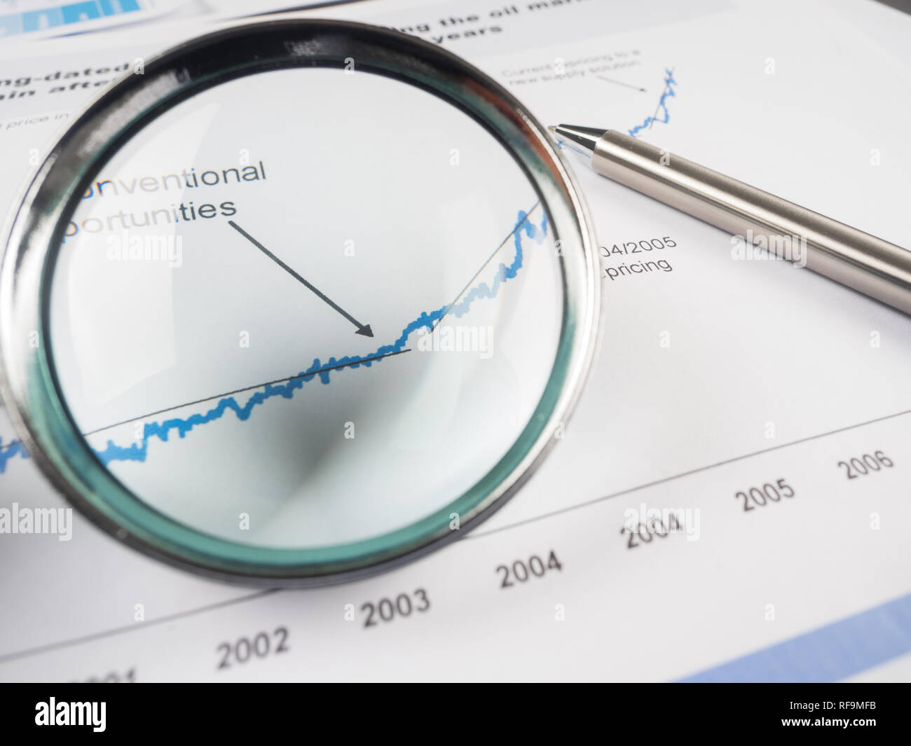 Business Data Analyzing, with magnifying glass and other on the desk ...